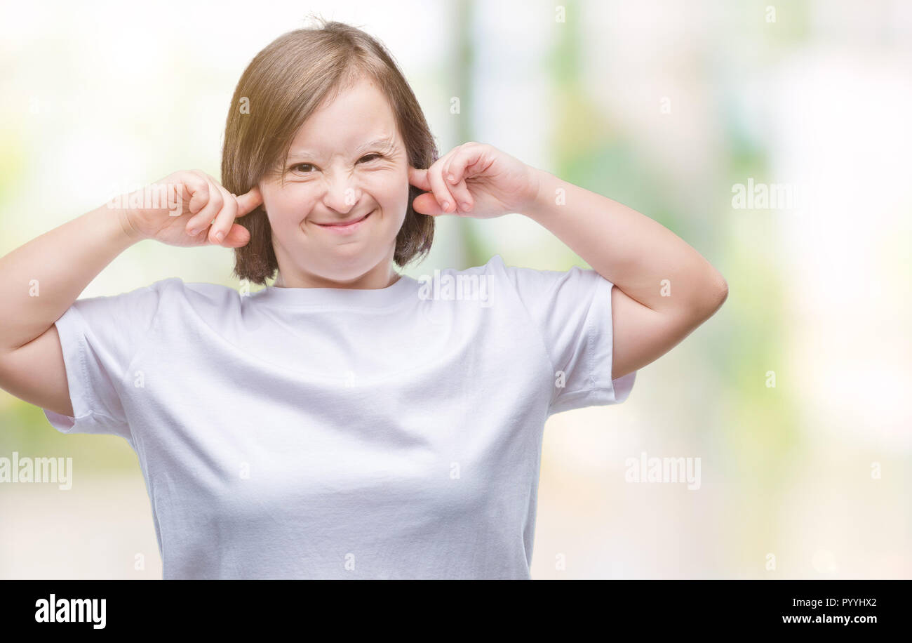 Young adult woman with down syndrome over isolated background covering ...