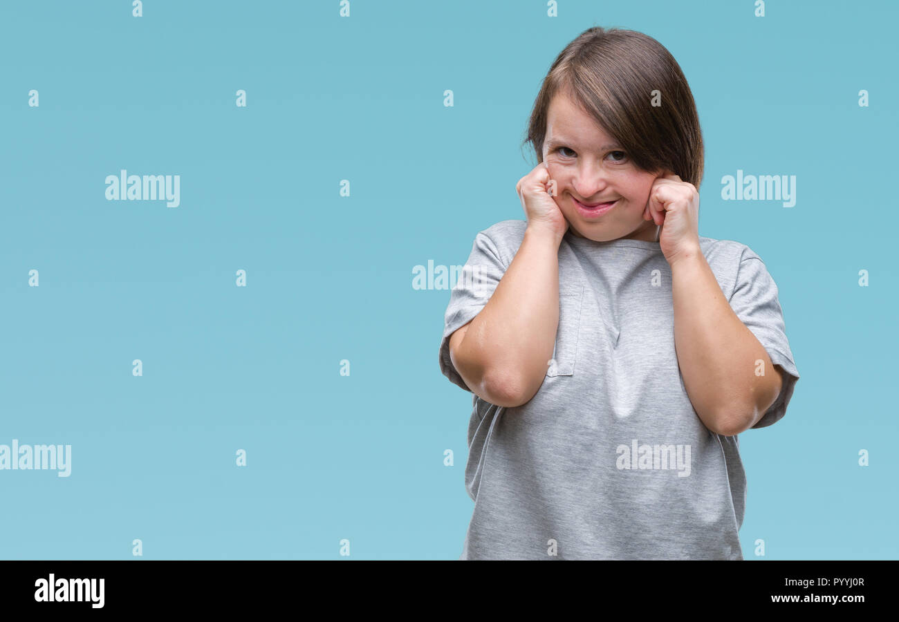 Young adult woman with down syndrome over isolated background covering ...