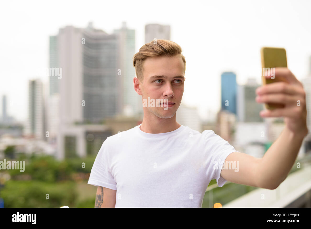 Young handsome man taking selfie with mobile phone Stock Photo - Alamy