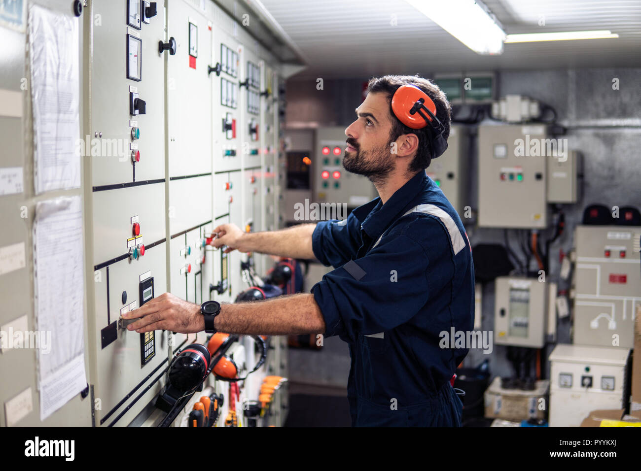 Marine engineer officer working in engine room Stock Photo - Alamy