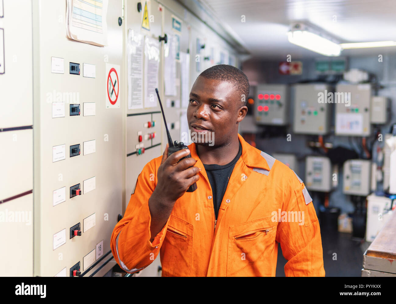 Marine engineer officer working in engine room Stock Photo - Alamy