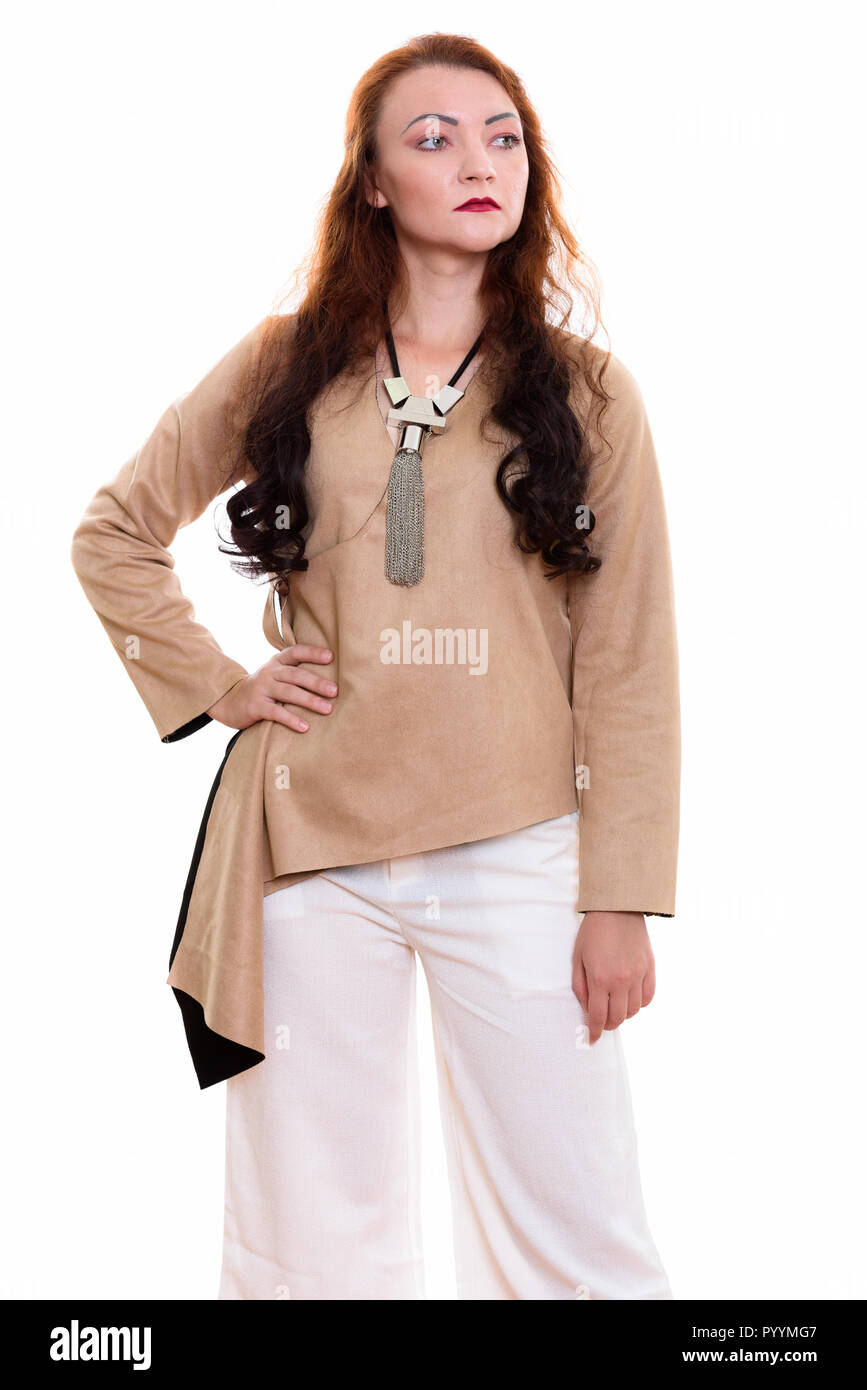 Studio shot of woman standing while thinking Stock Photo - Alamy