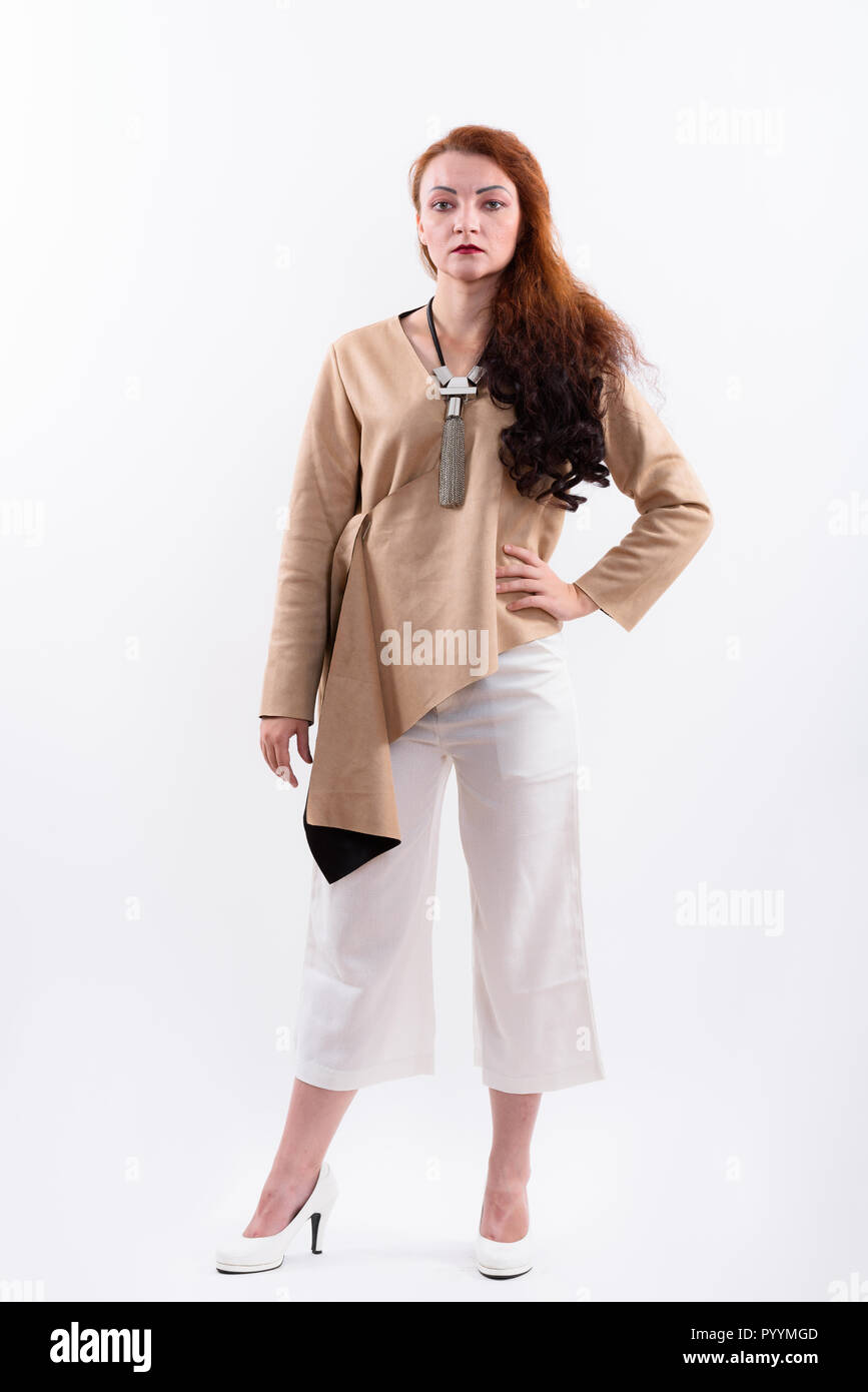 Full body shot of woman standing and looking at camera Stock Photo - Alamy