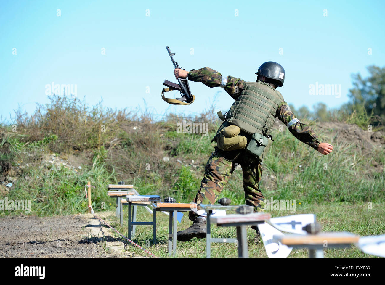 On a military shooting range, training: Ukrainian soldier throwing a ...