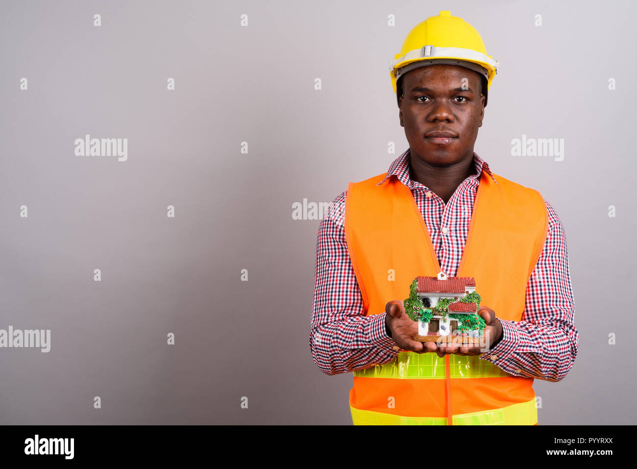 Young African man construction worker against white background Stock ...