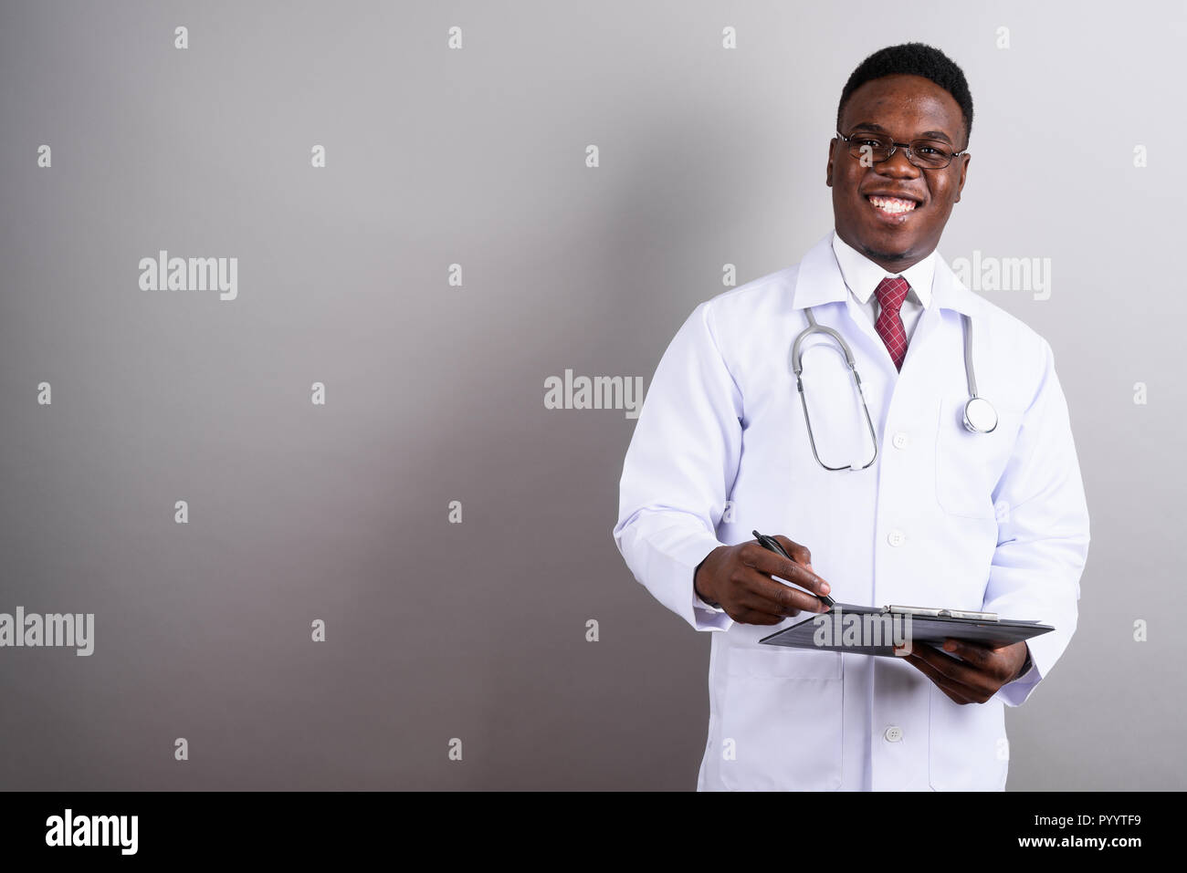 Young African man doctor against white background Stock Photo - Alamy
