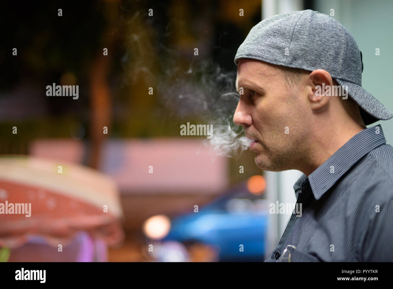 Handsome man smoking cigarette hi-res stock photography and images - Alamy