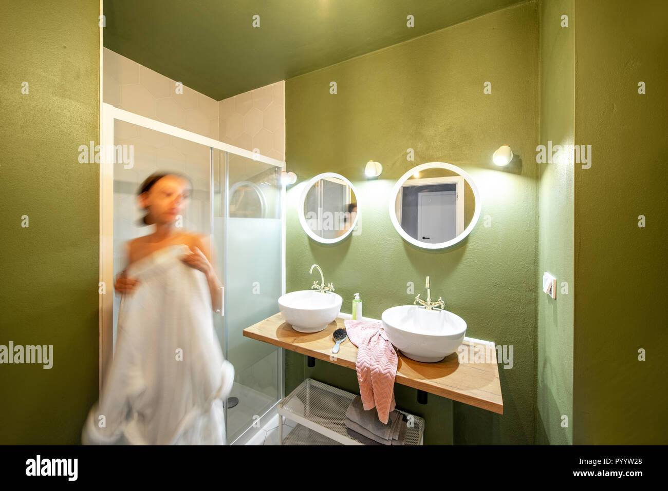 Beautiful loft interior bathroom with motion blurred woman figure in ...