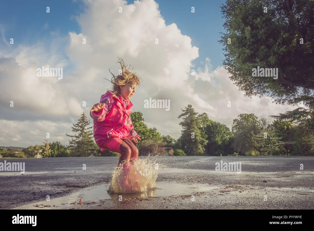 Girl jumping muddy puddle hi-res stock photography and images - Alamy