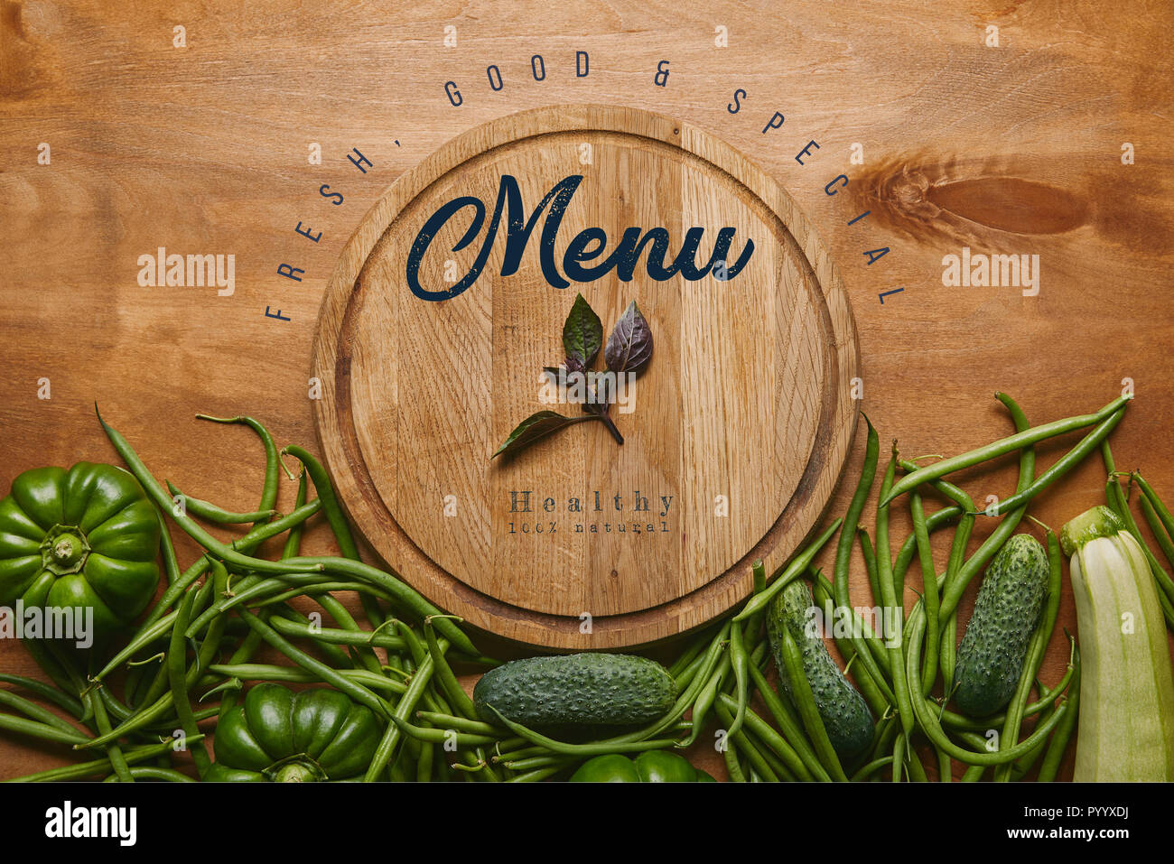 Organic raw green vegetables with wooden cutting board with "healthy ...