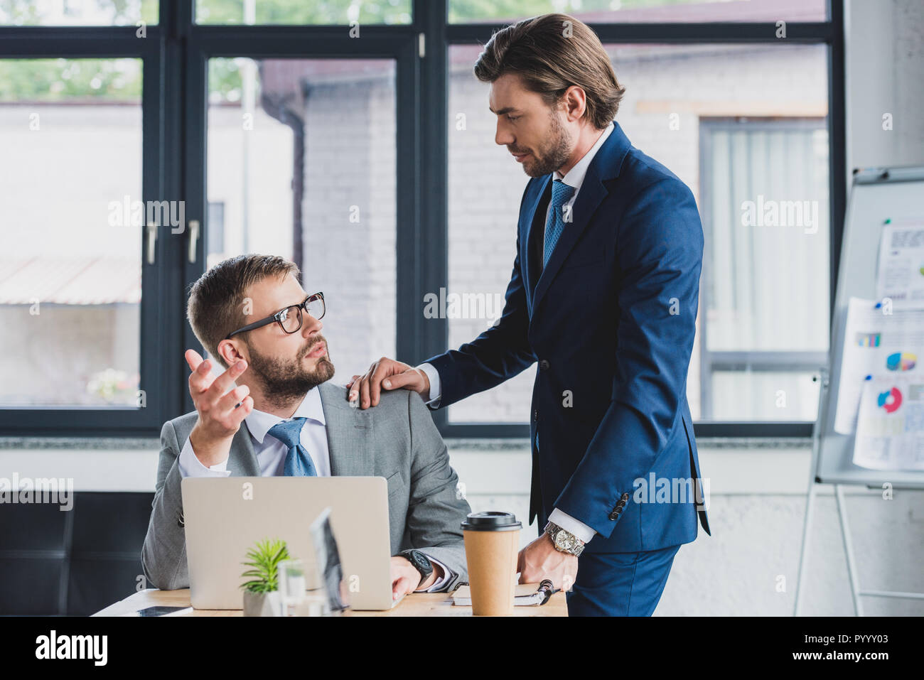 Serious young businessmen in hi-res stock photography and images - Alamy