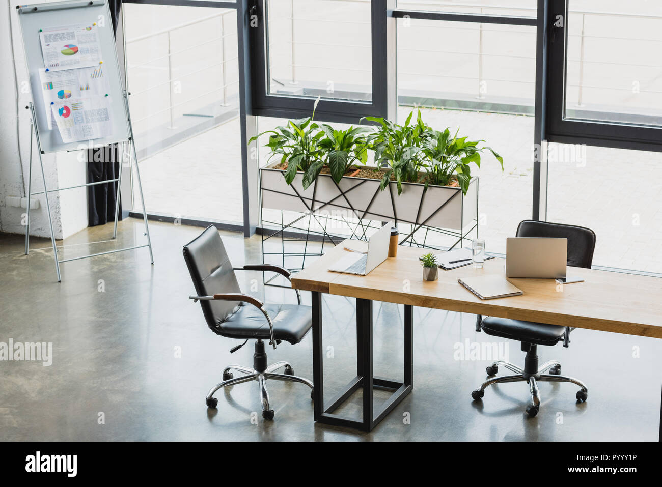 high angle view of modern office interior with electronics and business ...