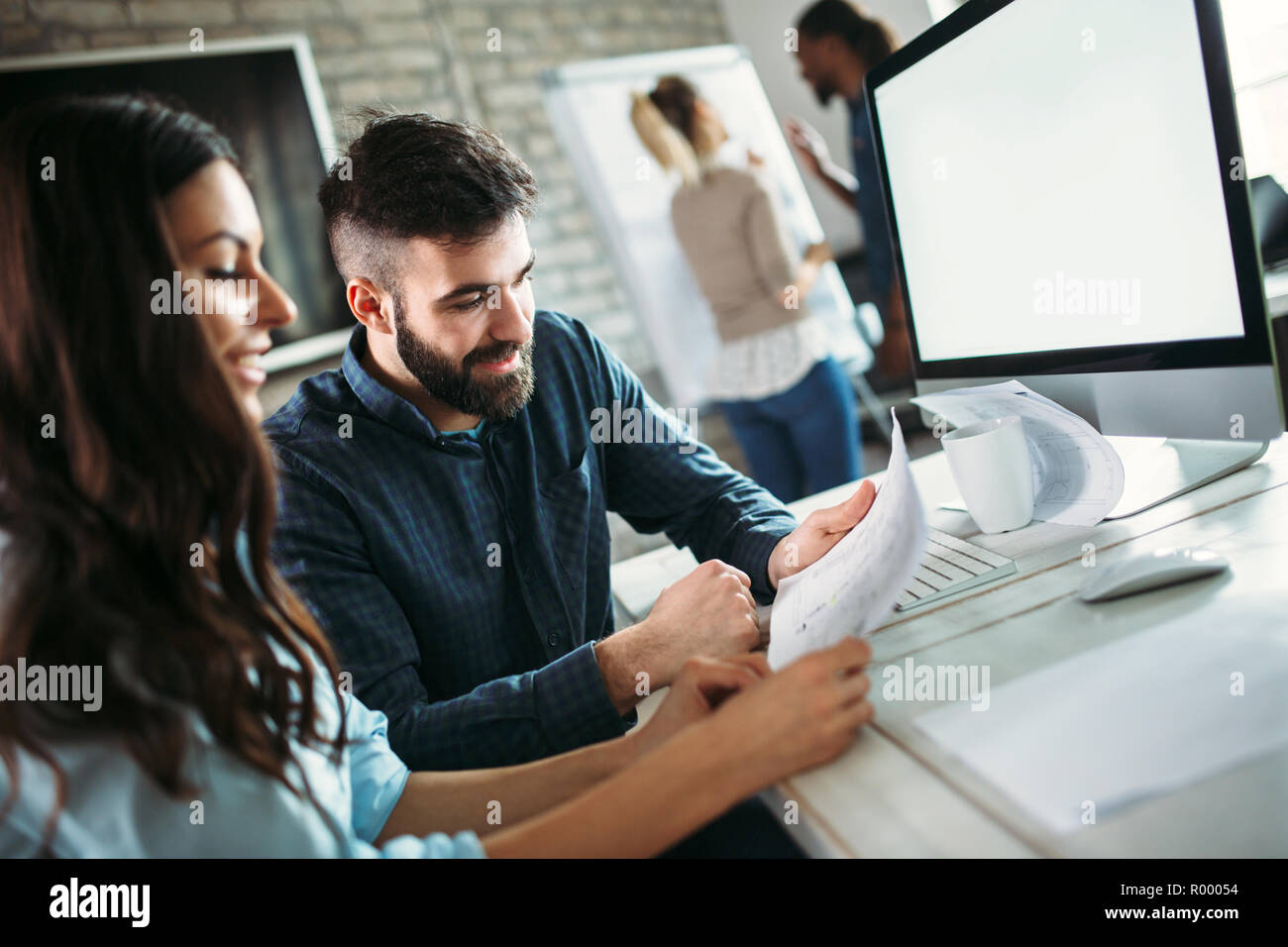 Young architects working on project in office Stock Photo - Alamy