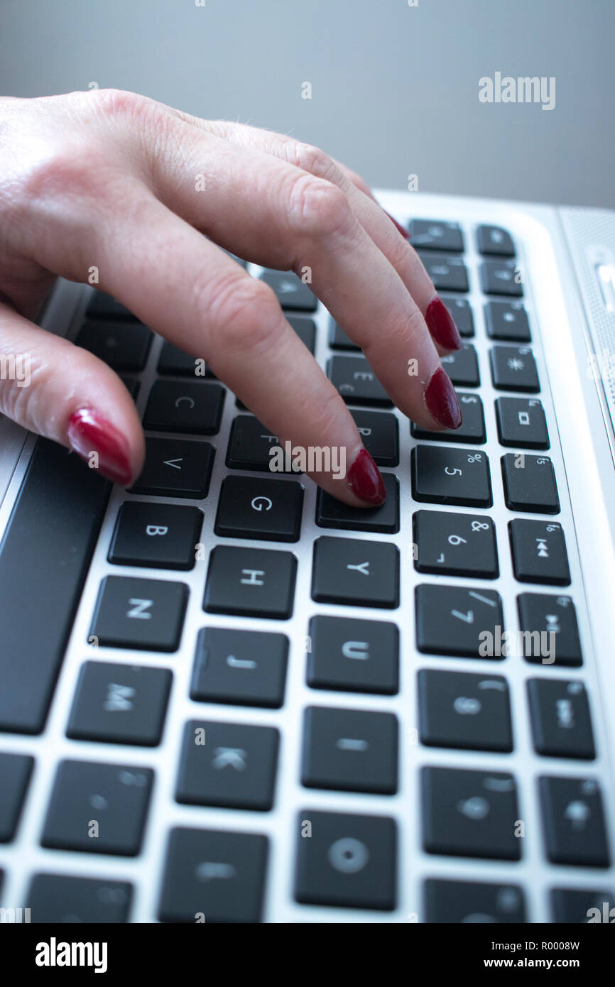 Secretary typist typing on laptop pc computer keyboard keys with hands ...