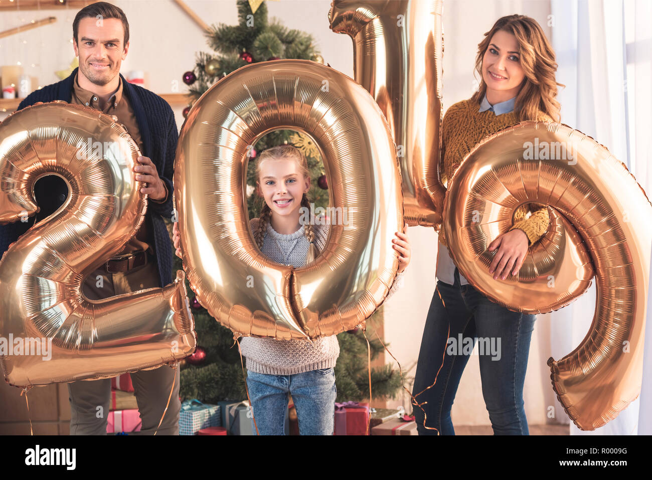 happy family with daughter holding 2019 new year golden balloons Stock ...