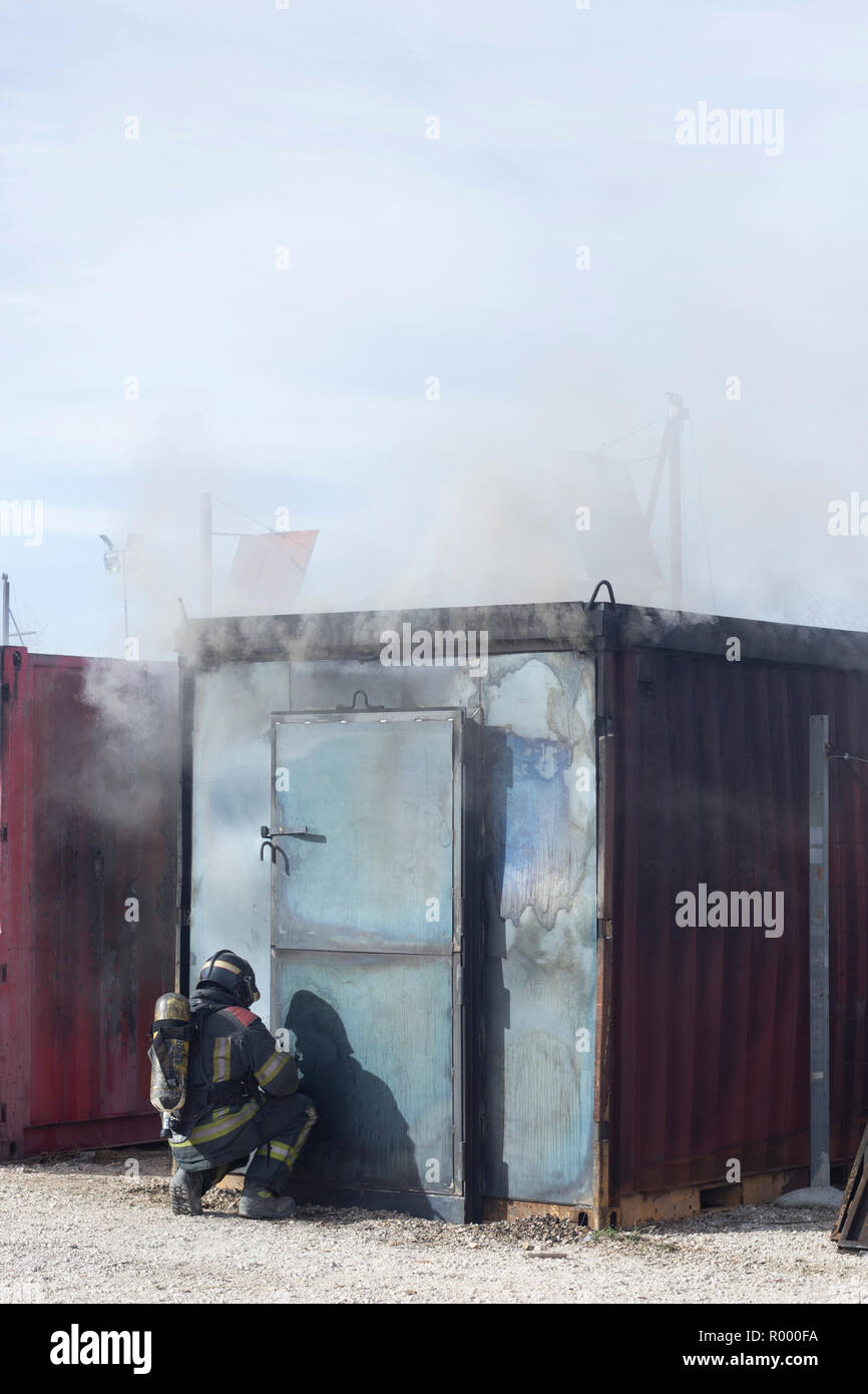 Firefighter putting out fire training station extinguisher backdraft ...