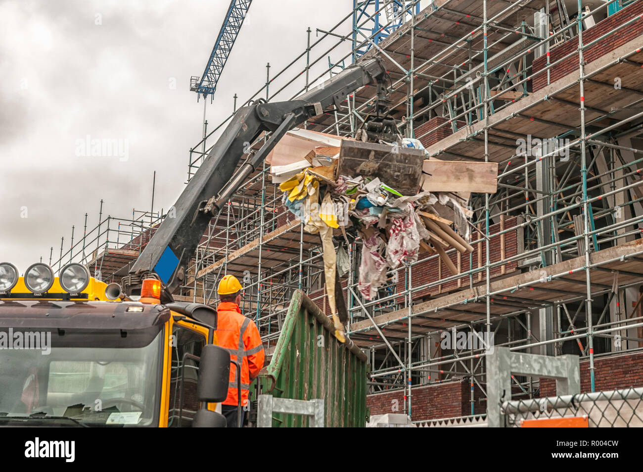 crane operator removes construction waste with a grab operated from a ...
