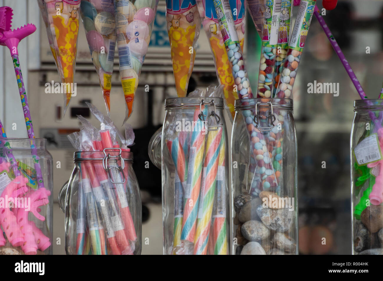 various Seaside sticks of rock and sweets for sale in jars at the beach ...
