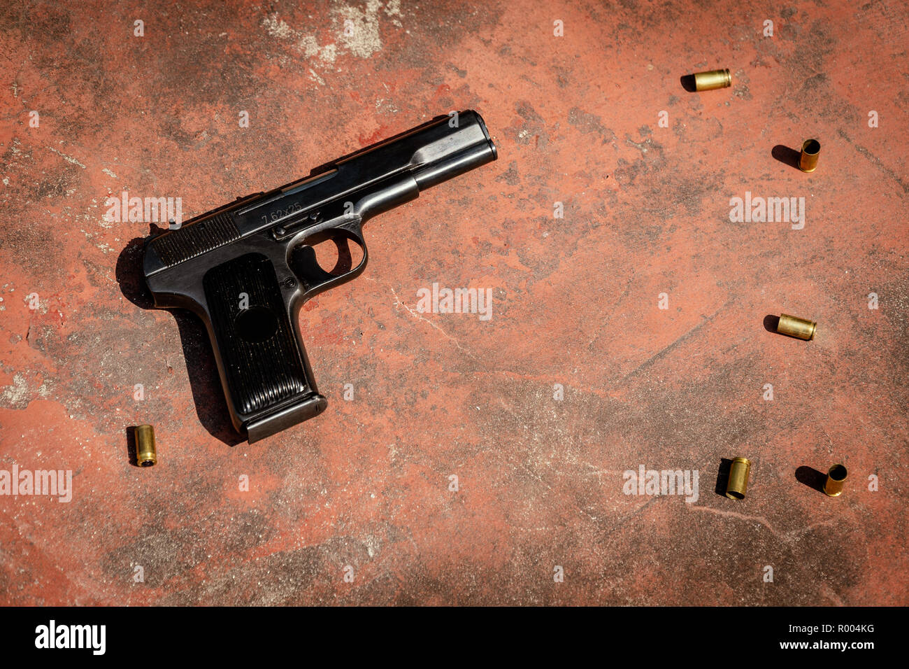 Old russian Auto Pistol on the concrete red backgroound Stock Photo - Alamy