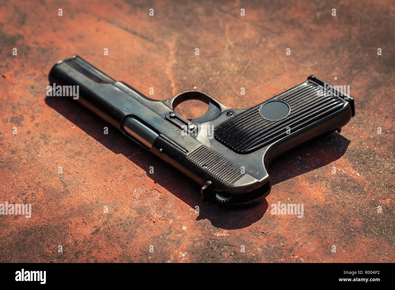 Old russian Auto Pistol on the concrete red backgroound Stock Photo - Alamy