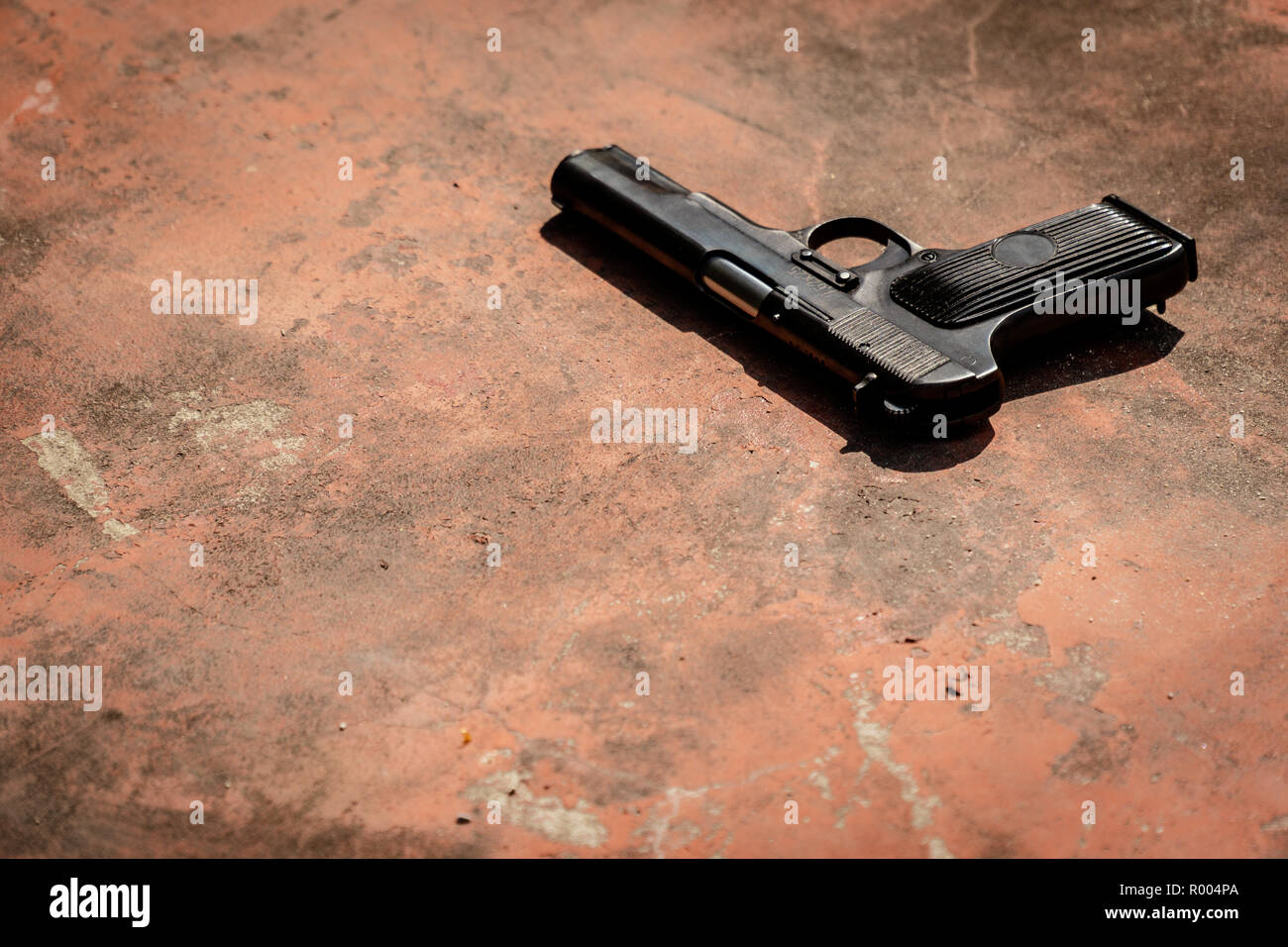 Old russian Auto Pistol on the concrete red backgroound Stock Photo - Alamy
