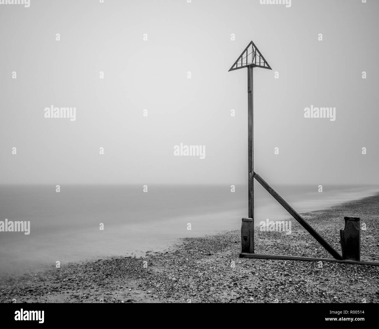 Beach marker black and white long exposure with calm sea and sea fog ...
