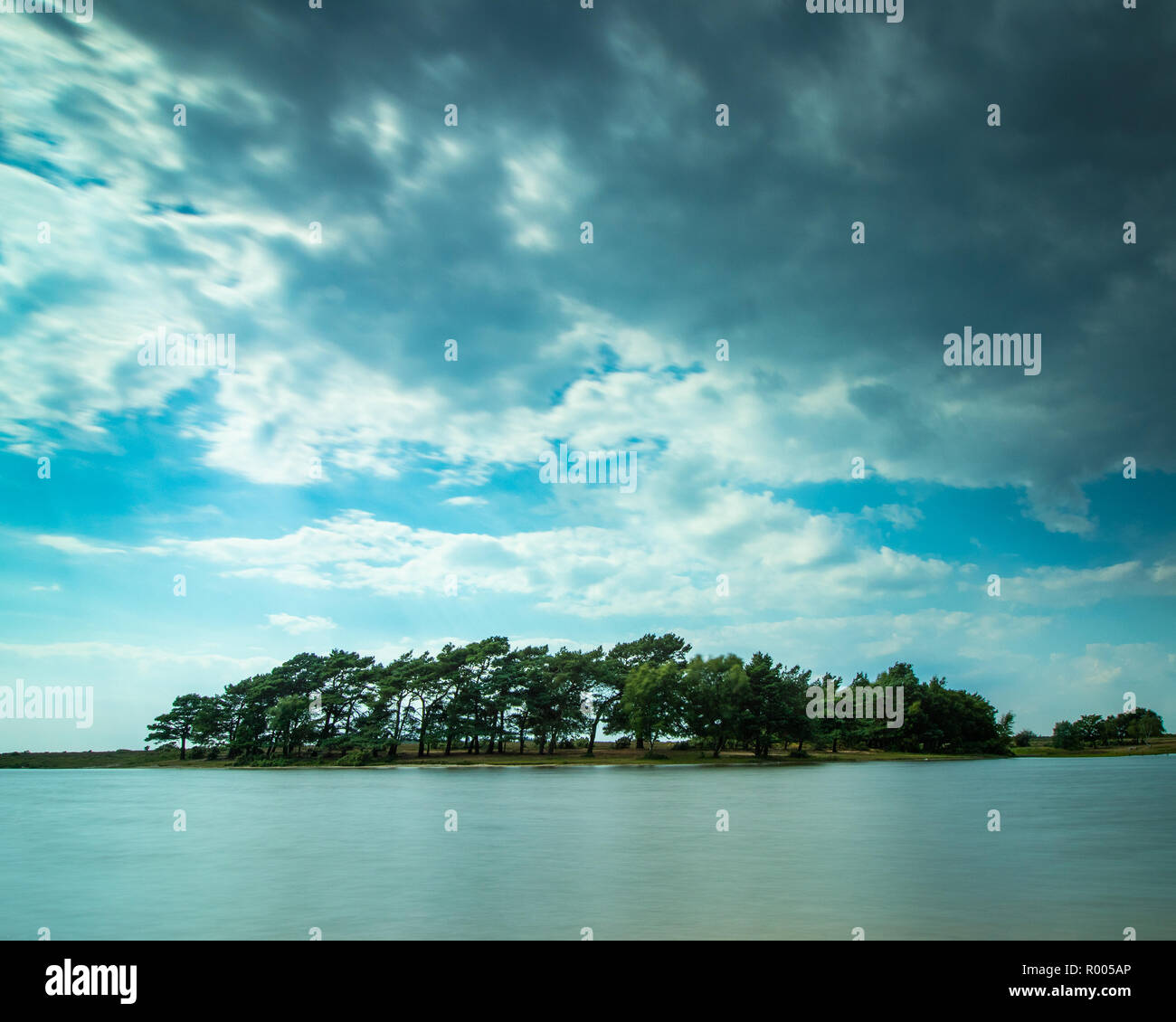 blue sky and blue still lake,Hatchet pond long exposure, New forest ...