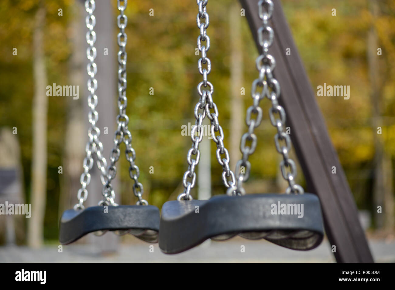 Playground swing seat in chains Stock Photo - Alamy