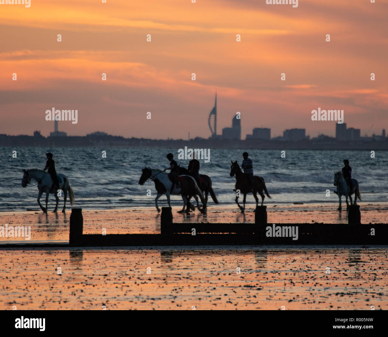 Riding horses at sunset hi-res stock photography and images - Alamy