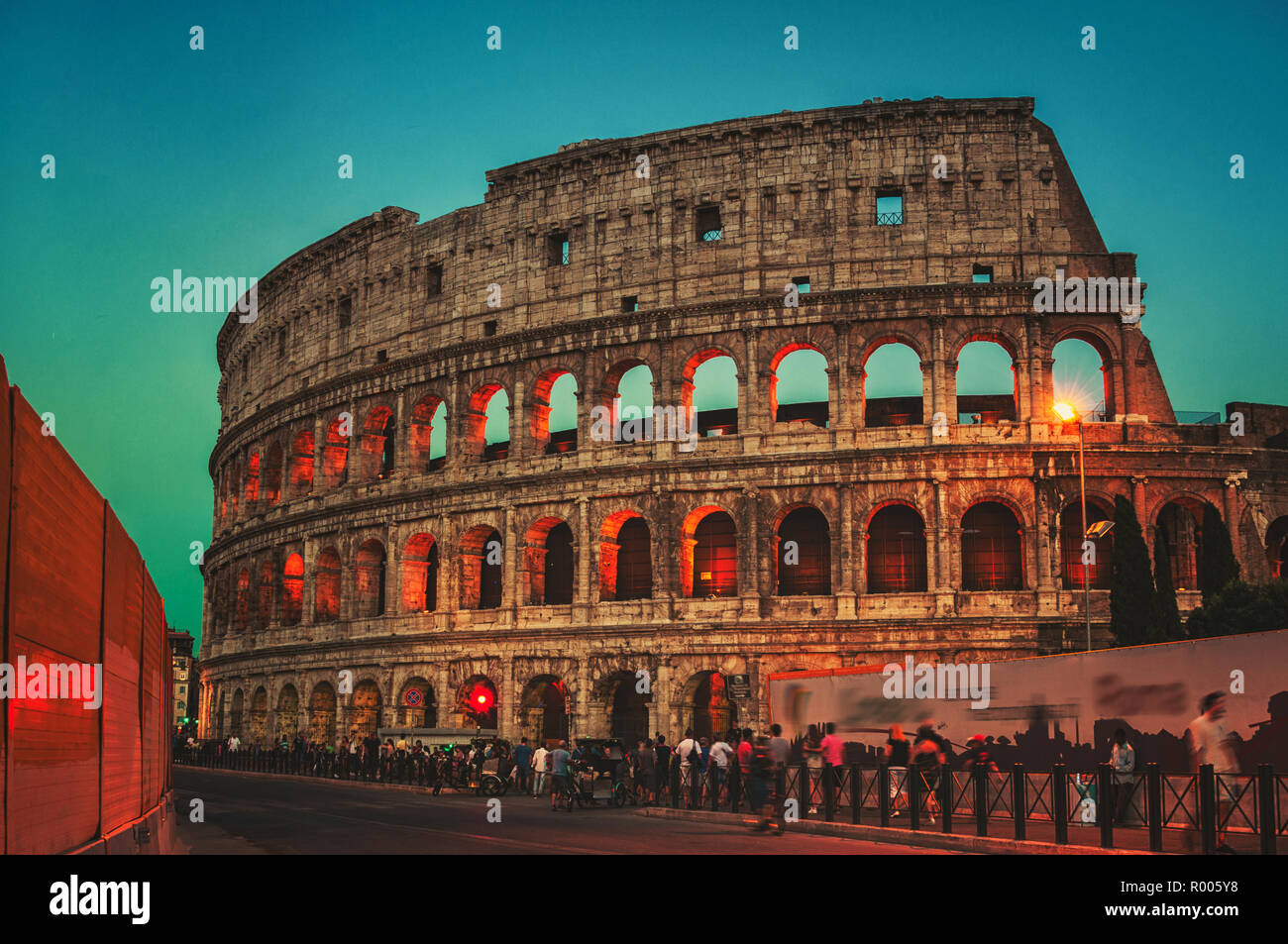 Rome, Italy. People in front of the illuminated Colosseum at sunset ...
