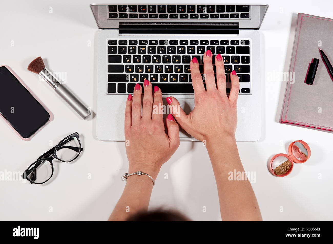 Laptop with woman's hands. Workplace designer Stock Photo - Alamy