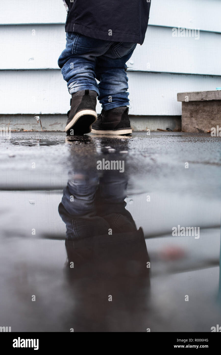 Child jumping in puddle hi-res stock photography and images - Alamy