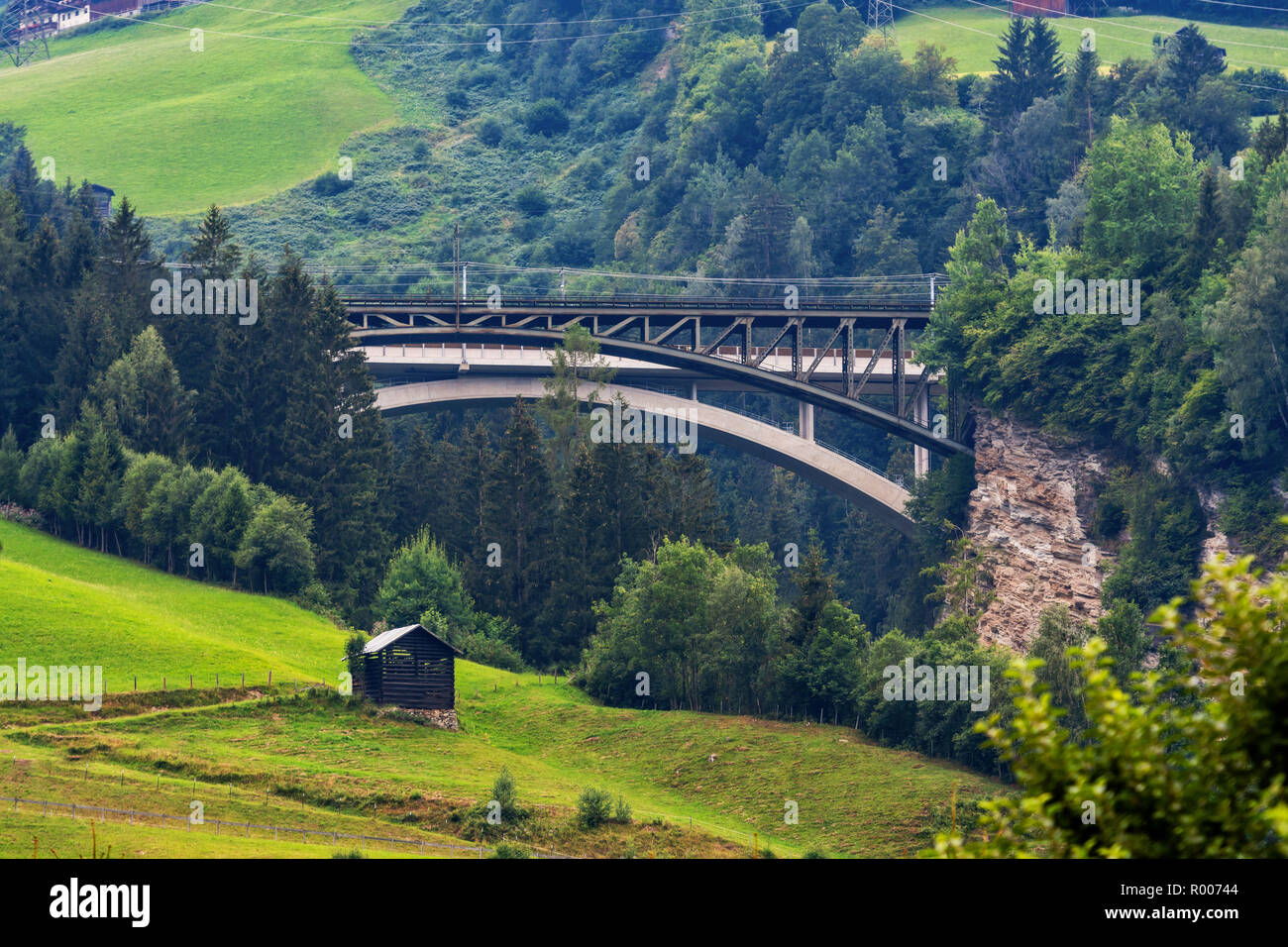 A picturesque Alpine landscape with an old railway bridge. Austria ...
