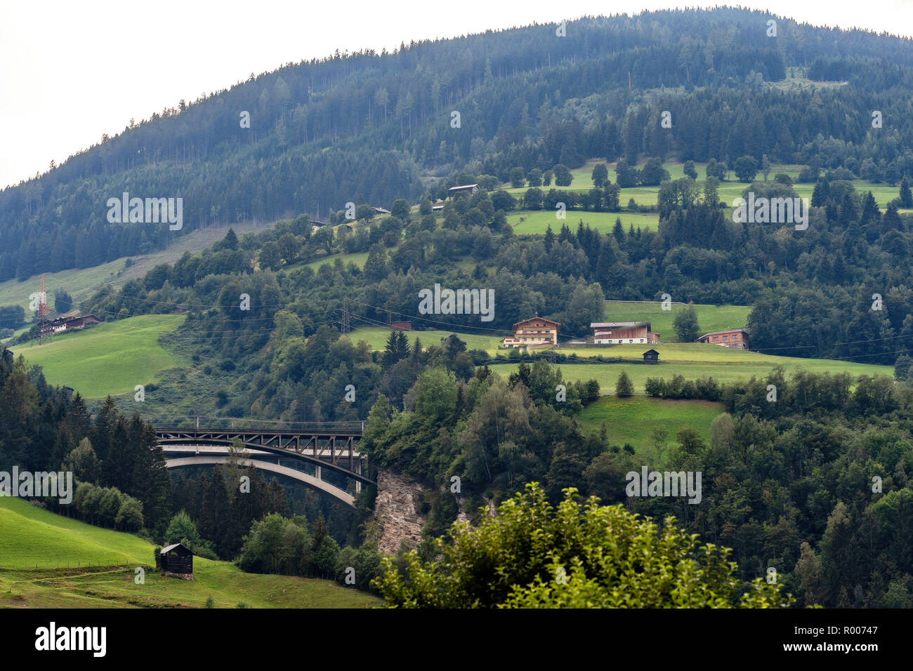 A picturesque Alpine landscape with an old railway bridge. Austria ...