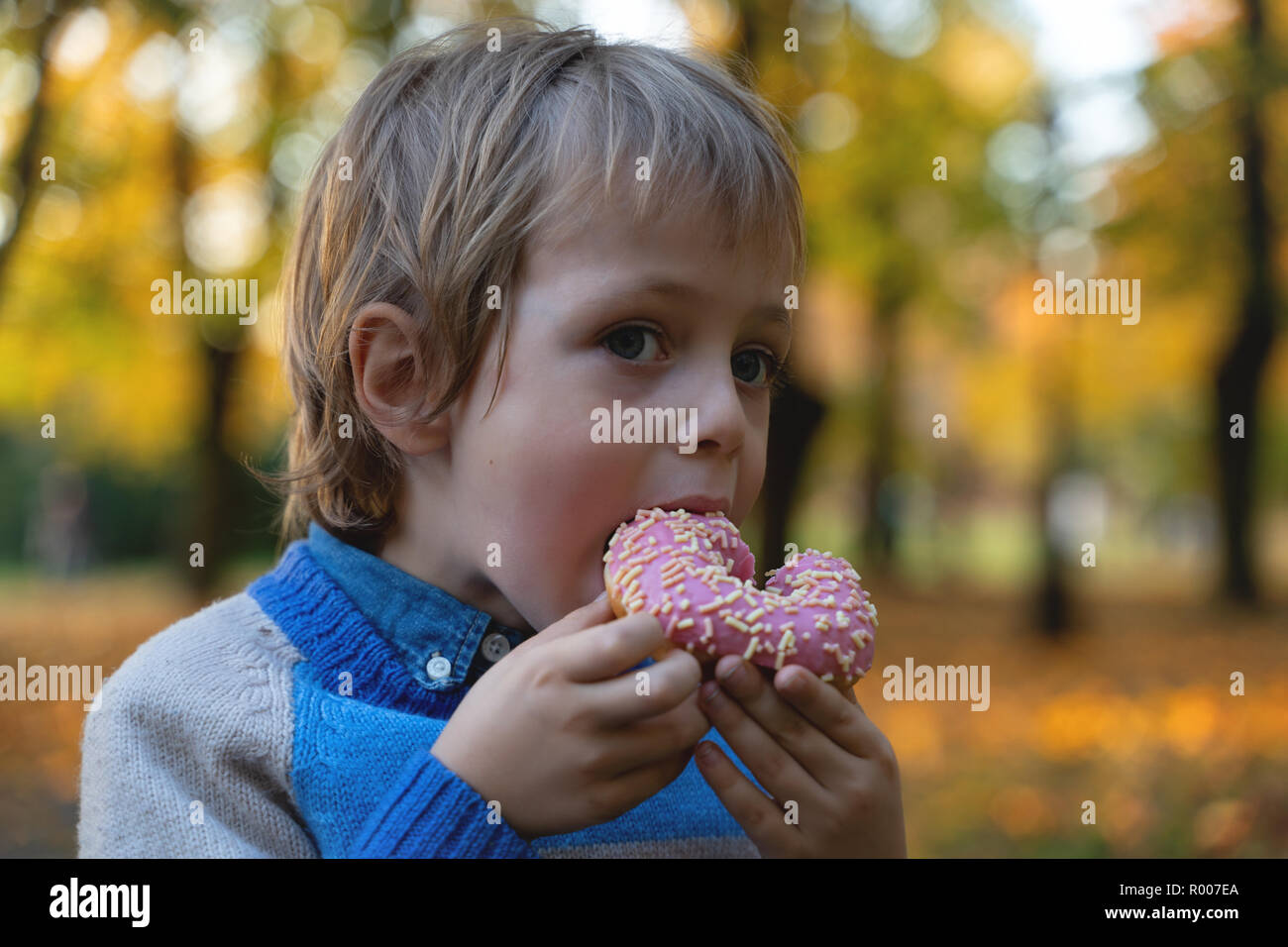 Boy eating donuts hi-res stock photography and images - Alamy