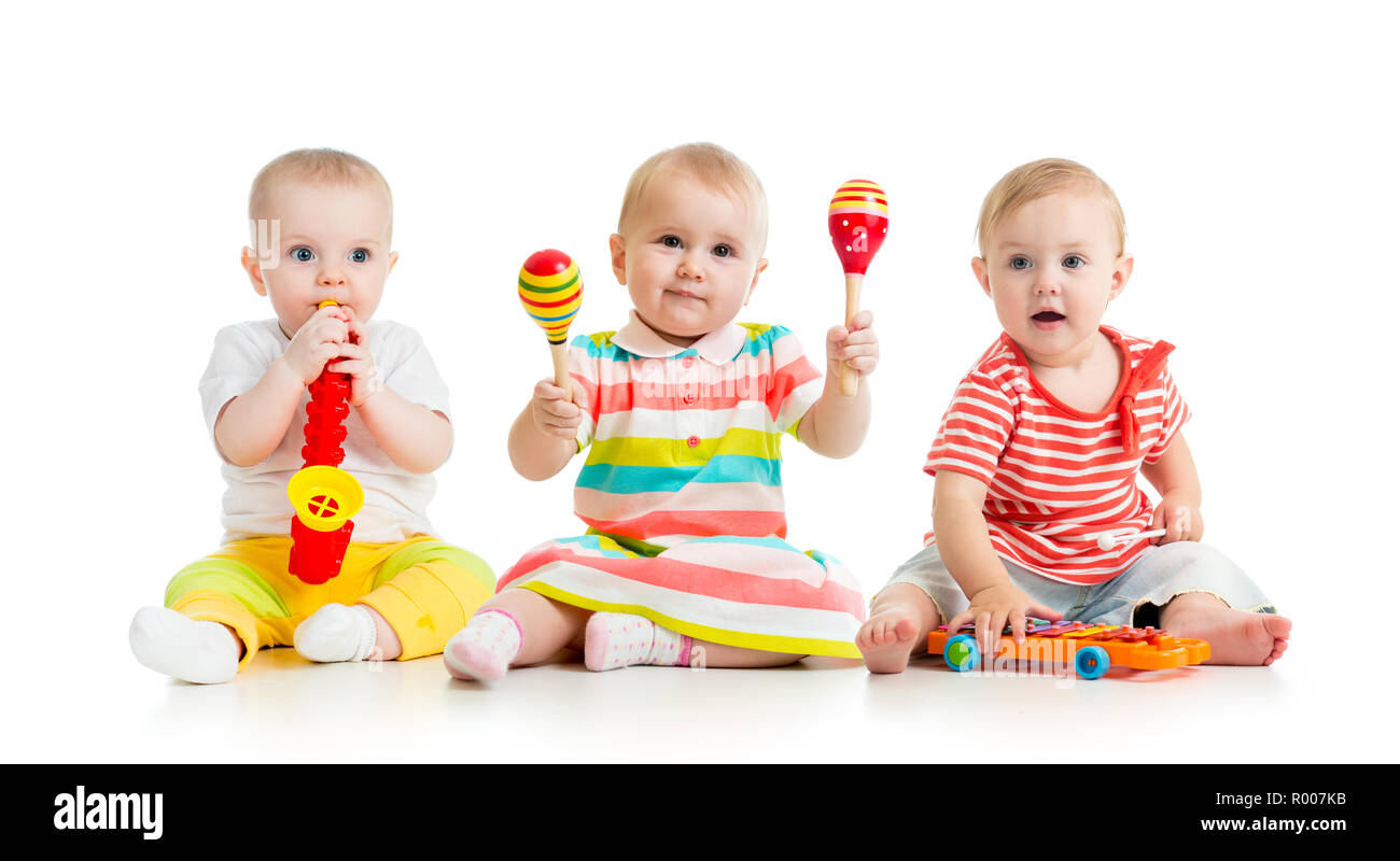 Children babies toddlers playing with musical toys. Isolated on white ...