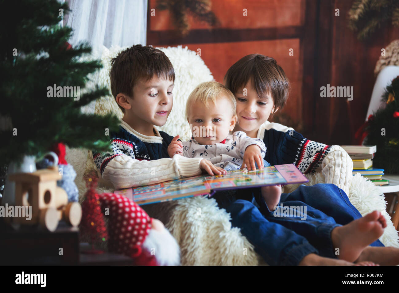 Little boy reading in armchair hi-res stock photography and images - Alamy