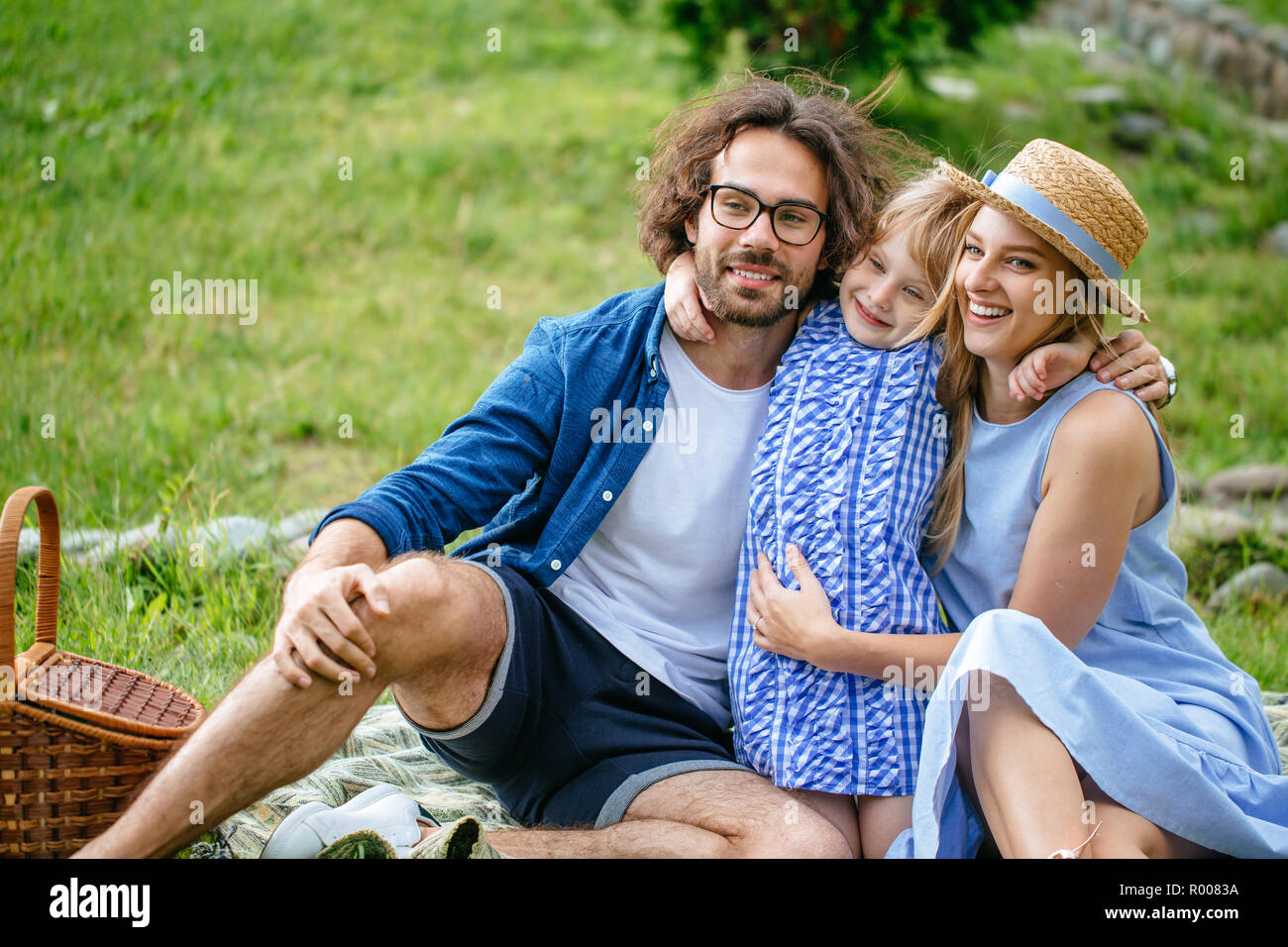 Family with child hugging and having fun outdoor Stock Photo - Alamy