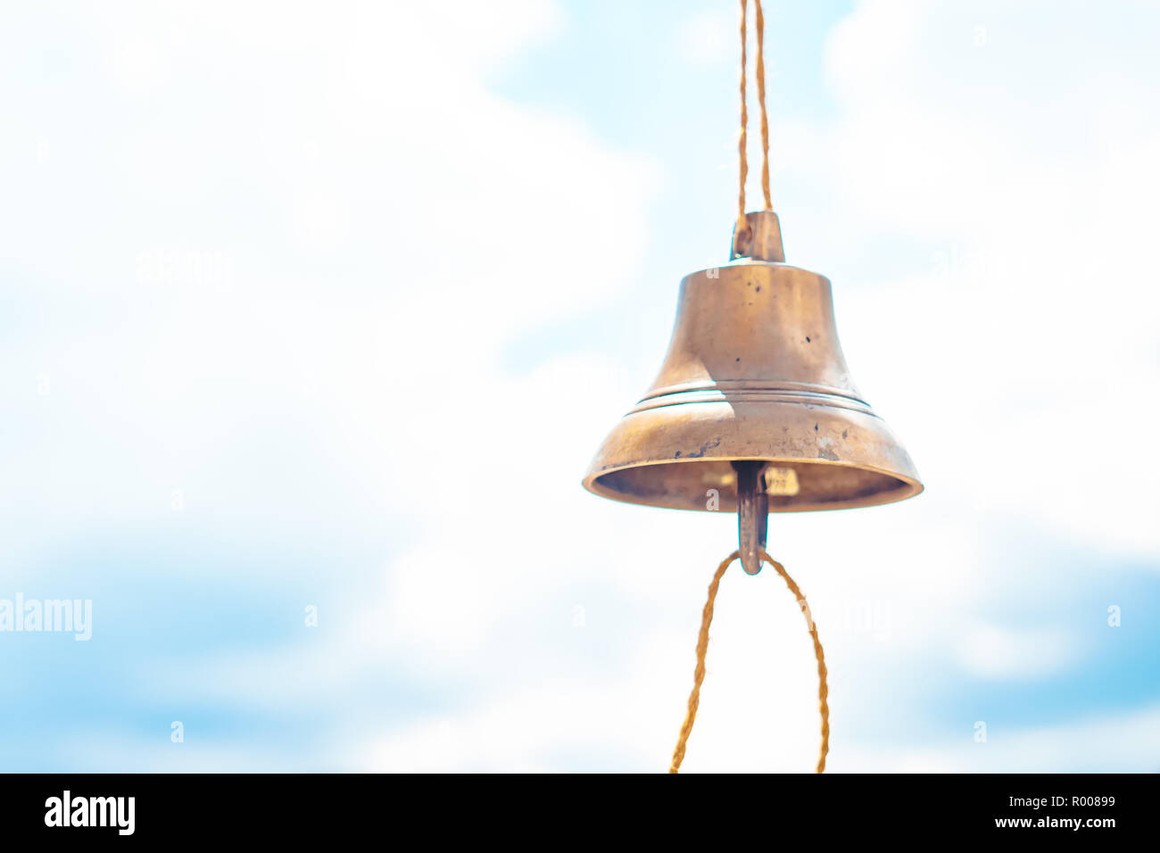 the bell hangs on a rope against the sky Stock Photo - Alamy