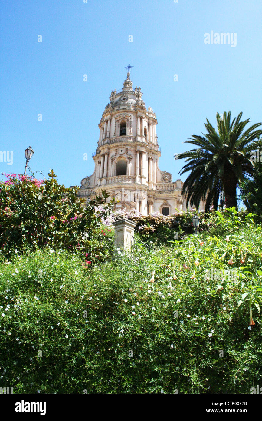 The baroque cathedral of Saint George at Modica,surrounded by lush ...