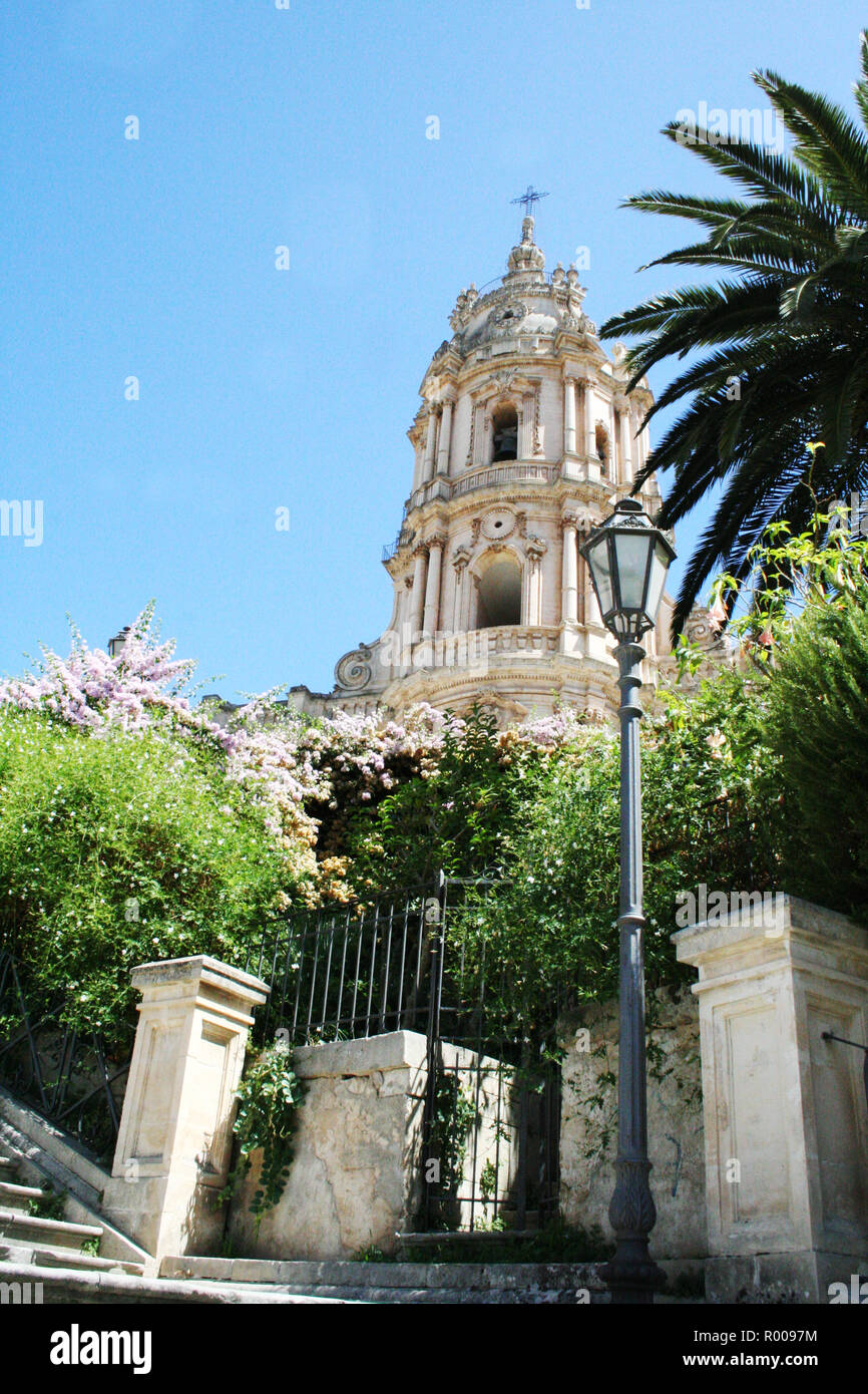 The baroque cathedral of Saint George at Modica,surrounded by lush ...