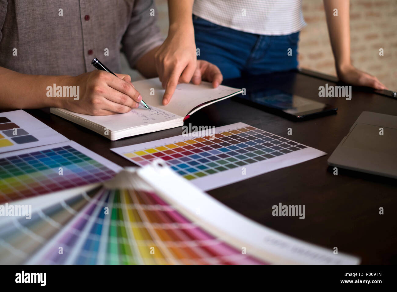 Graphic designers choose colors from the color bands samples for design ...