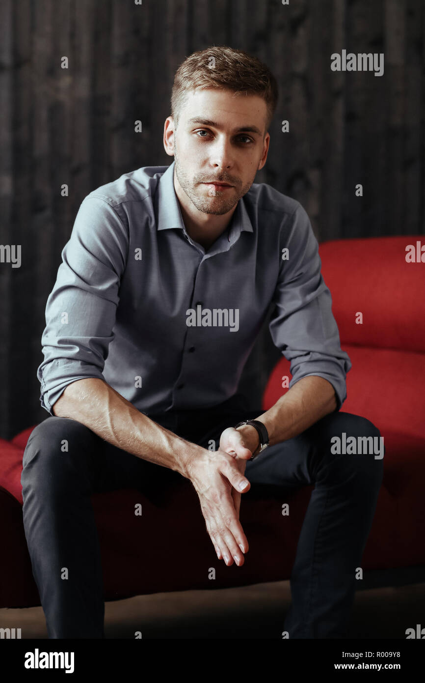 Handsome man on a wooden wall background Stock Photo - Alamy