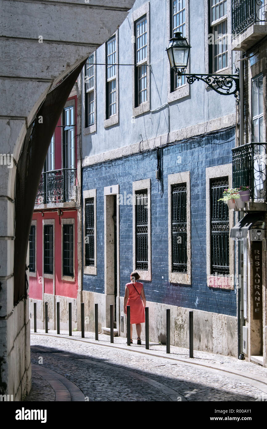 Tourist in the narrow streets of the Alfama district, Lisbon, Portugal ...