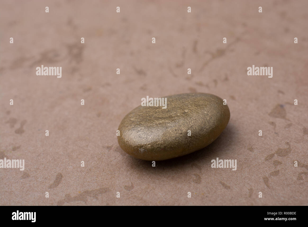Little gold color stone on with a background Stock Photo - Alamy
