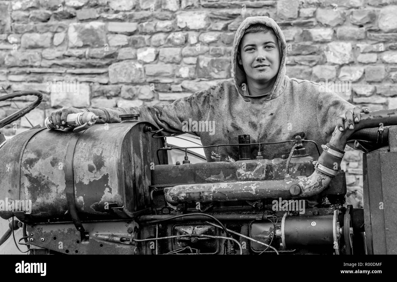 Young apprentice heavy goods mechanic posing by a tractor engine Stock ...