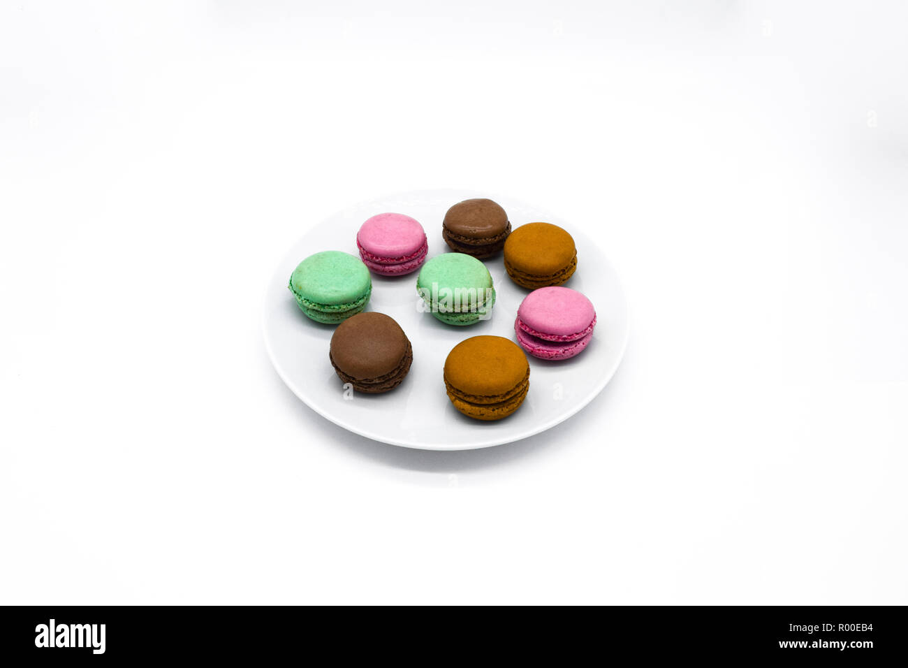 macarons on plate, sweet colorful macarons on white background Stock ...