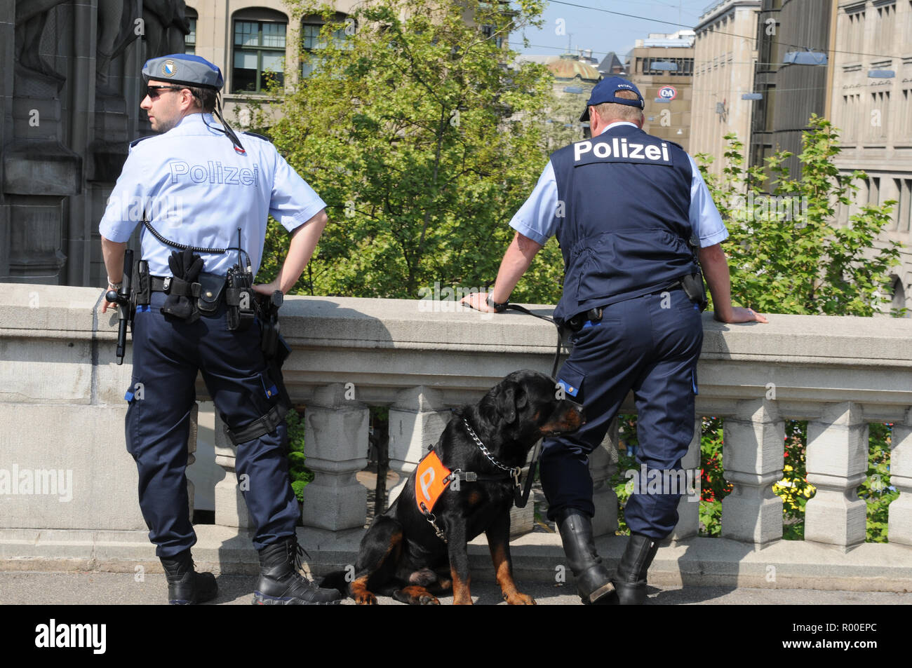 Switzerland: Two police men with a police dog obeying the demonstration ...