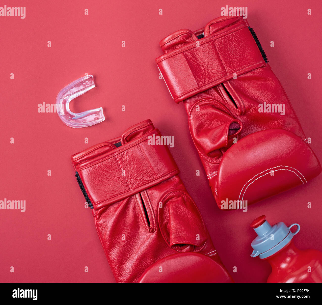 red boxing sport gloves, silicone mouthpiece for the teeth on a red ...