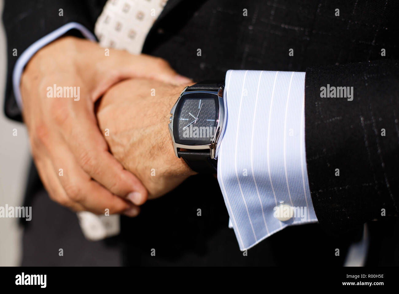 Man watching time on the wrist Stock Photo - Alamy